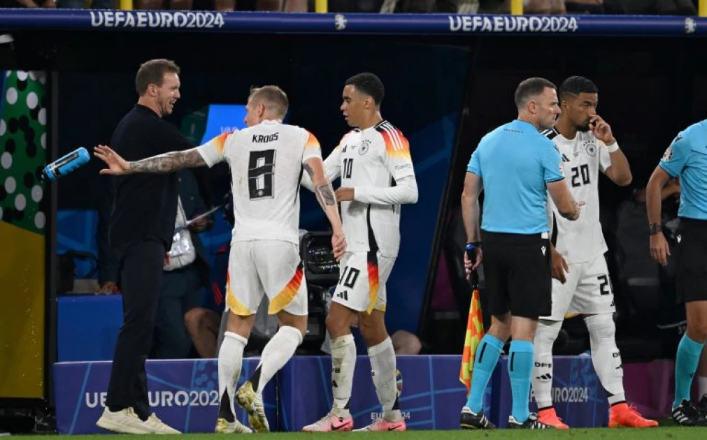 Euro hosts Germany pass Denmark test but clouds remain